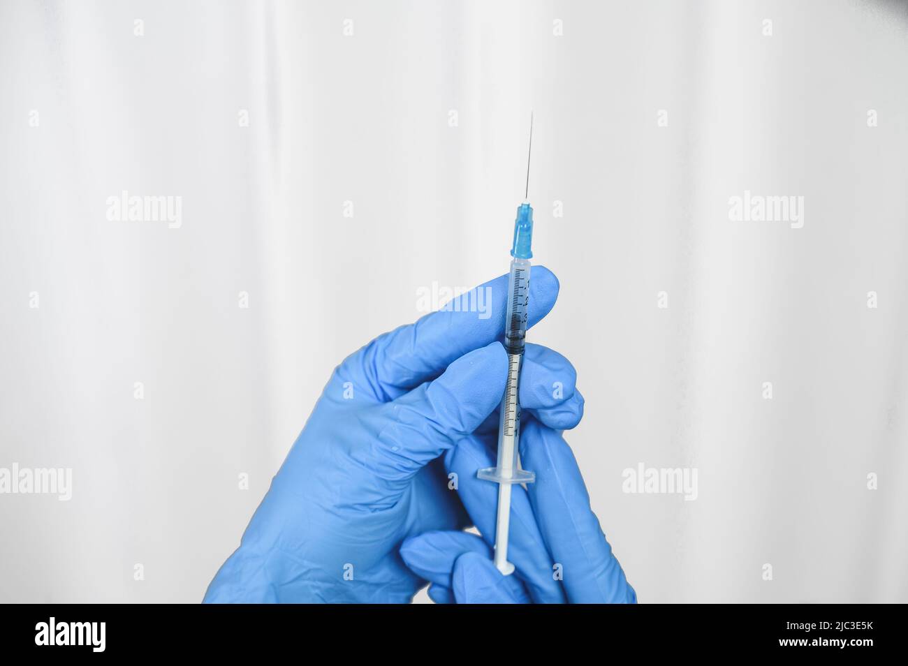 nurse hands holds a syringe with a vaccine for virus infection. The ...