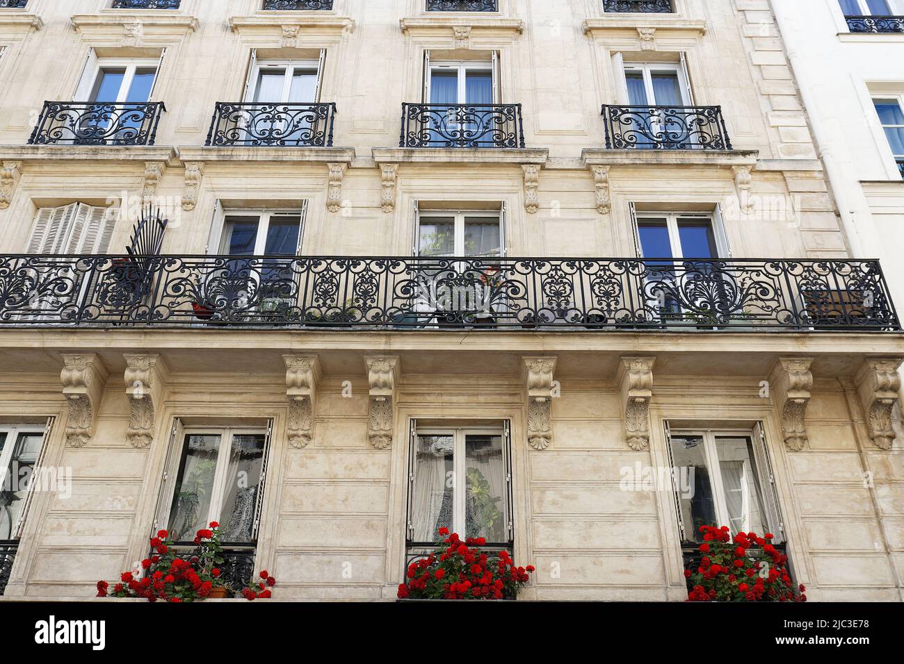 The facade of traditional French house with typical balconies and ...