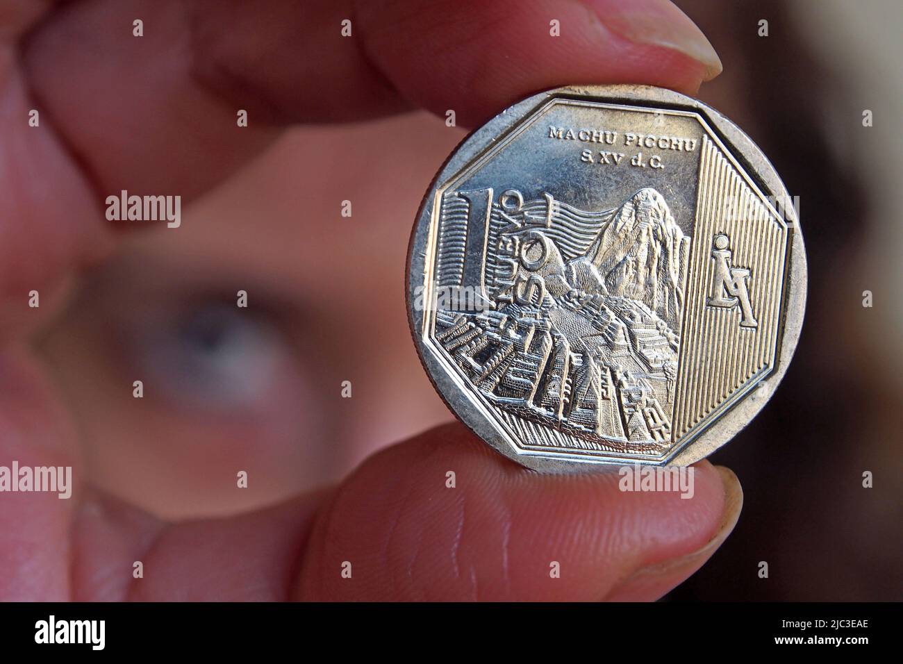 Peruvian coin; 2011 Un Nuevo Sol coin, with Machu Picchu theme, hold ...