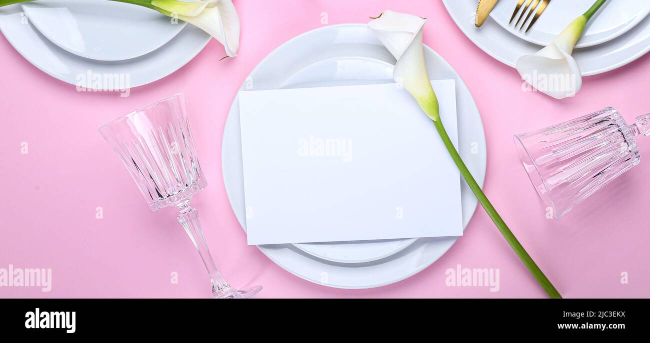 Beautiful table setting with calla lilies on pink background, top view ...