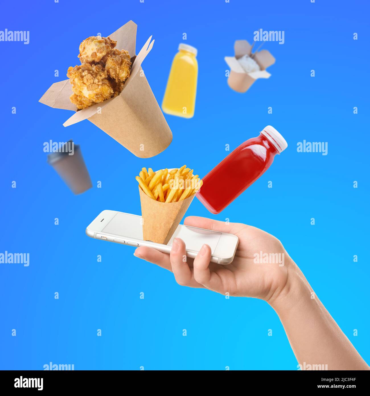 Human hand with smartphone and many tasty snacks on blue background ...