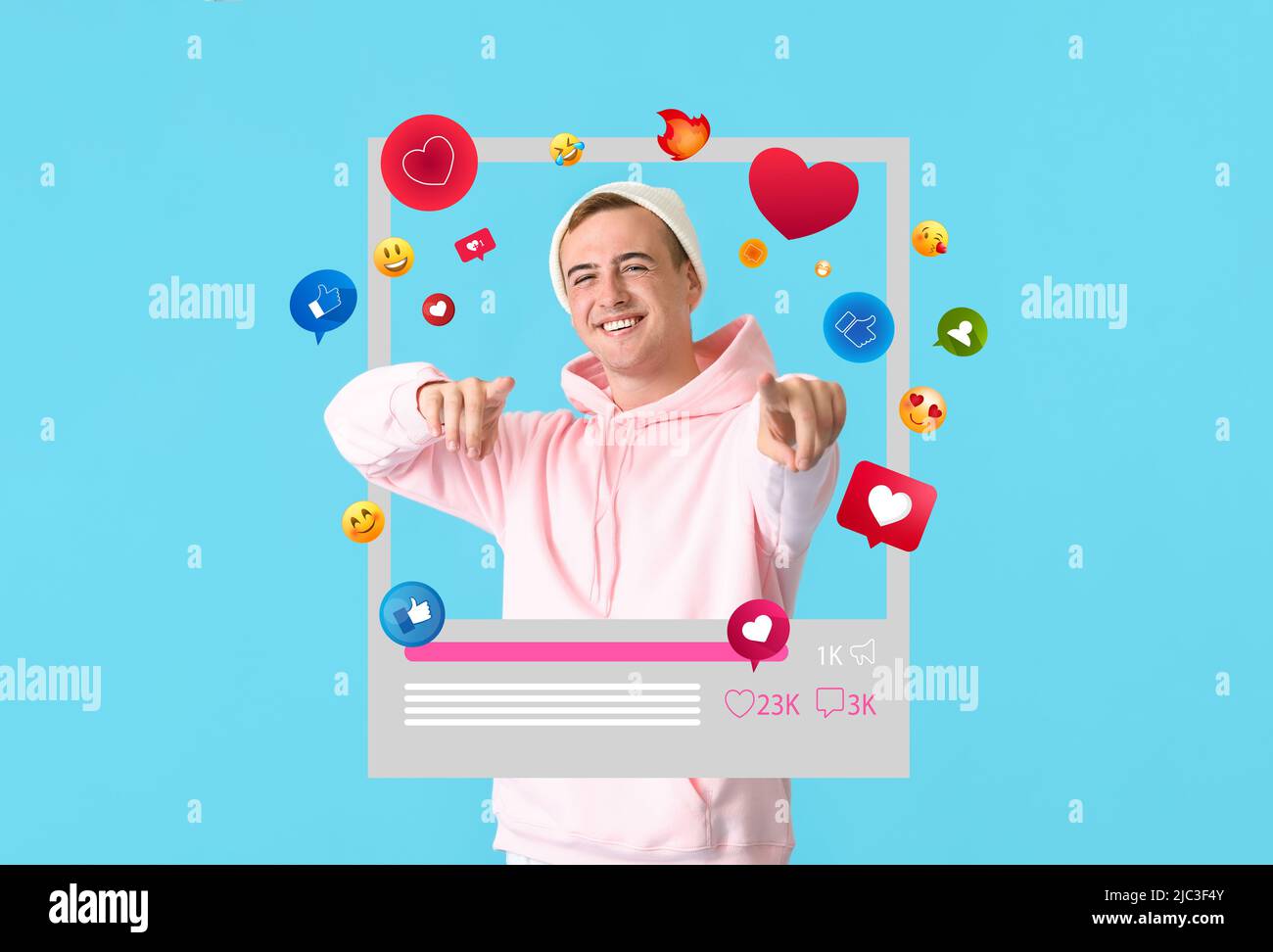 Happy young male blogger pointing on viewer against blue background ...