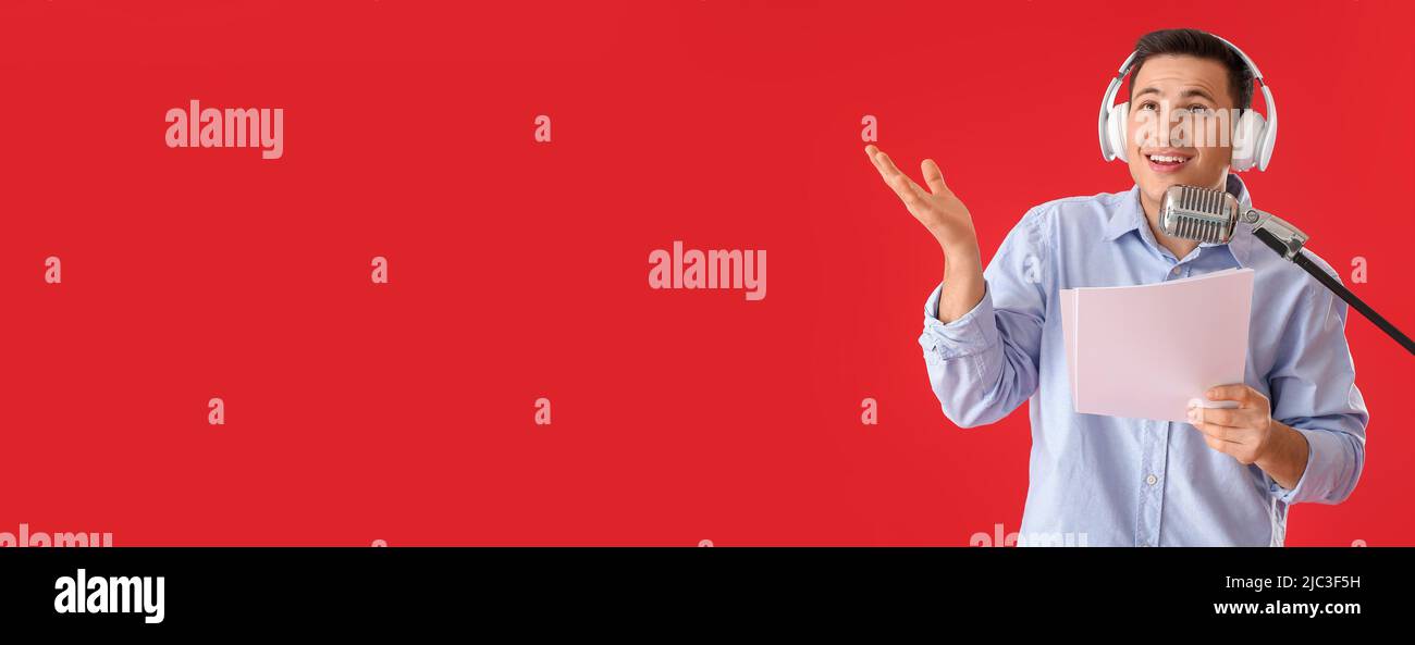 Male radio presenter with microphone on red background with space for ...