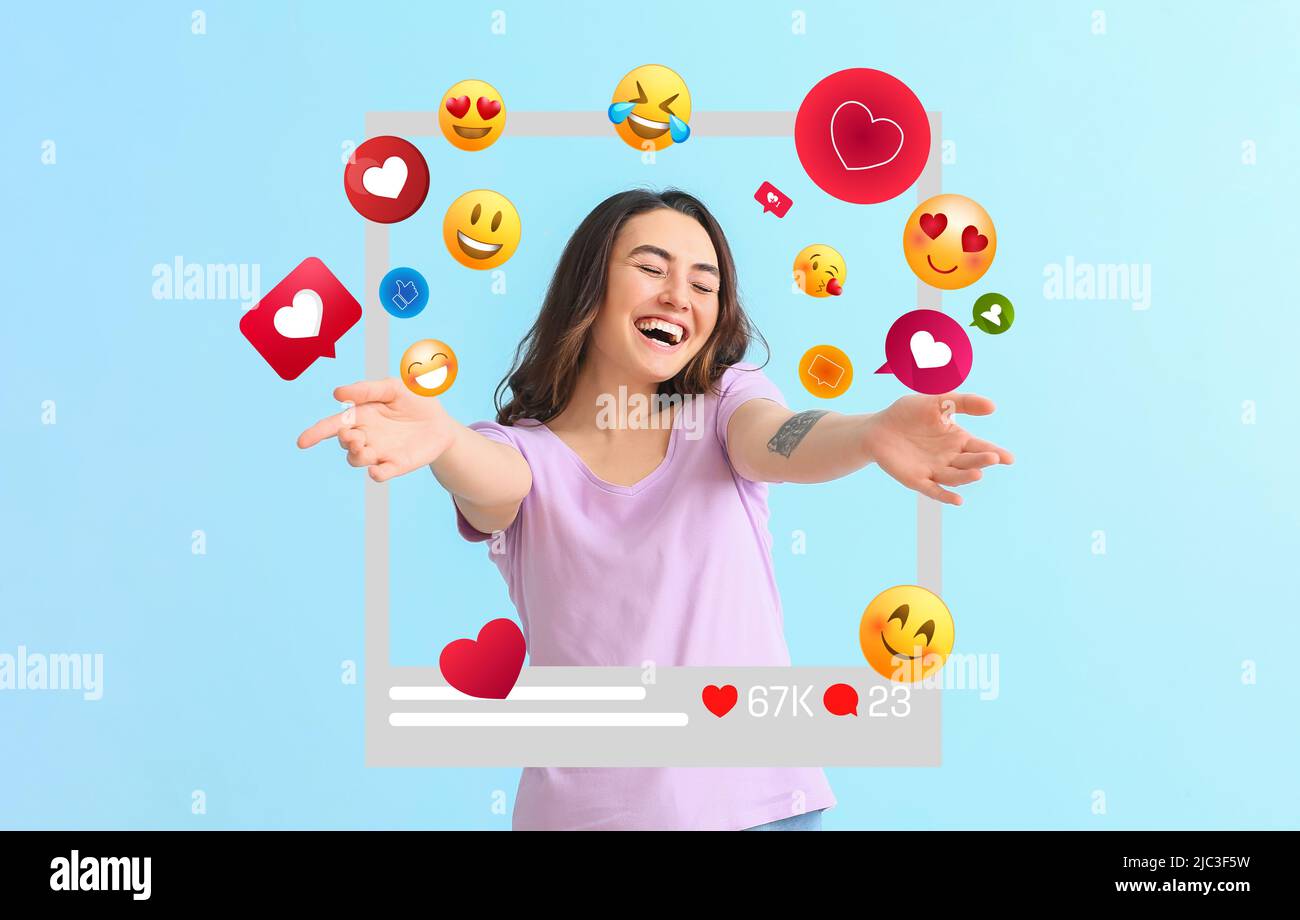 Happy young female blogger on blue background Stock Photo - Alamy