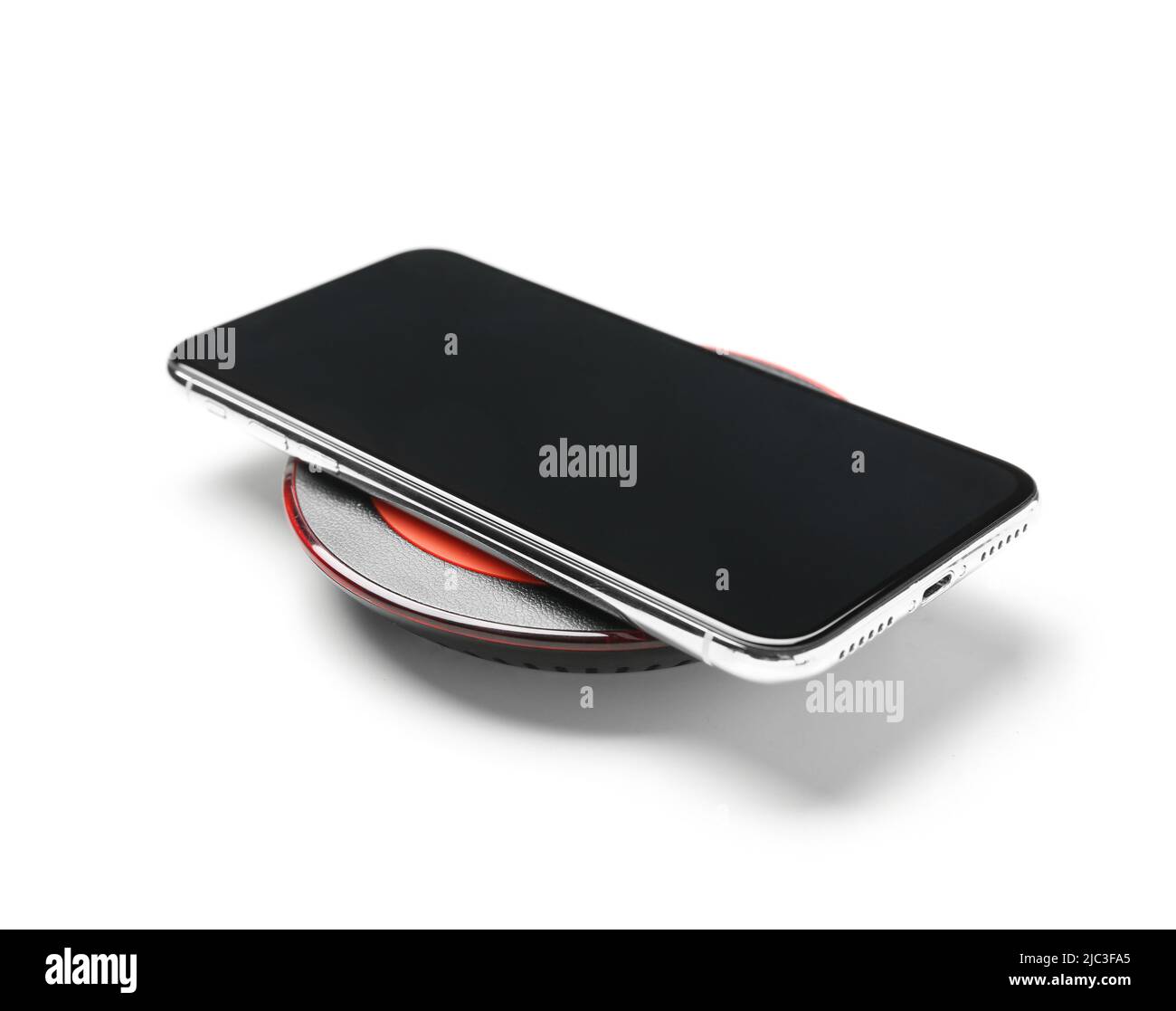 Wireless charger pad and modern mobile phone on white background Stock ...