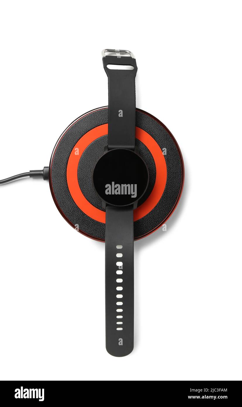 Wireless charger pad and smartwatch on white background Stock Photo - Alamy