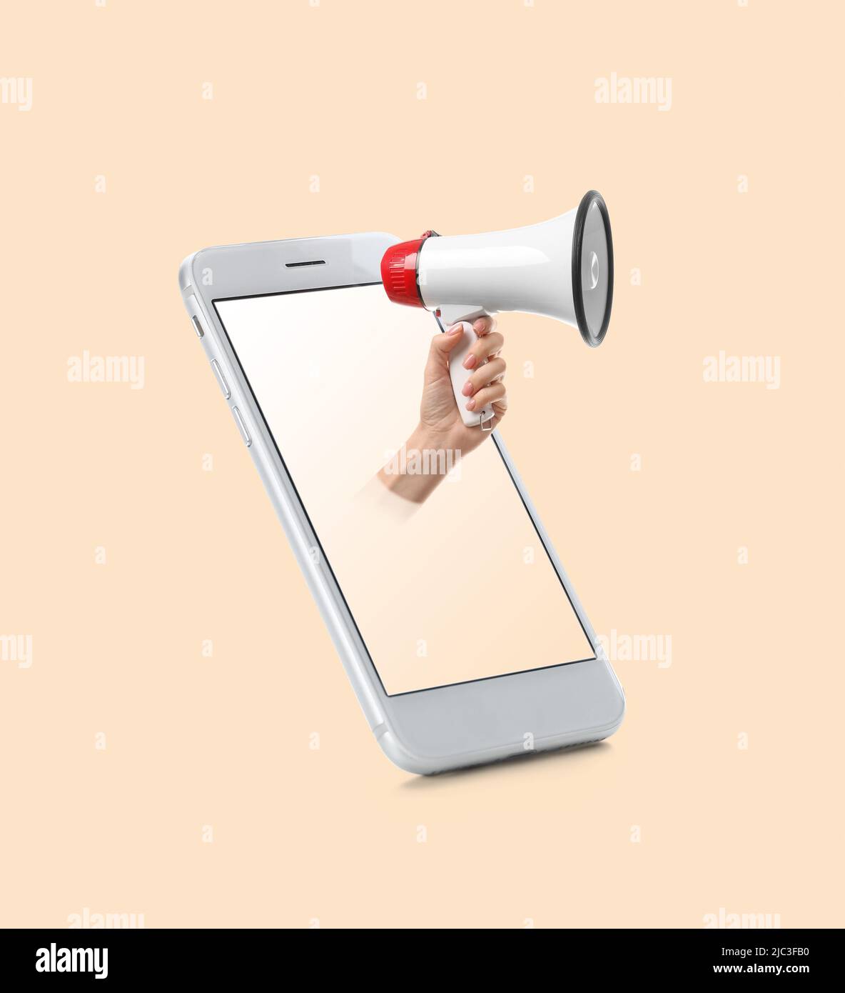 Mobile phone and hand with megaphone on light background Stock Photo ...