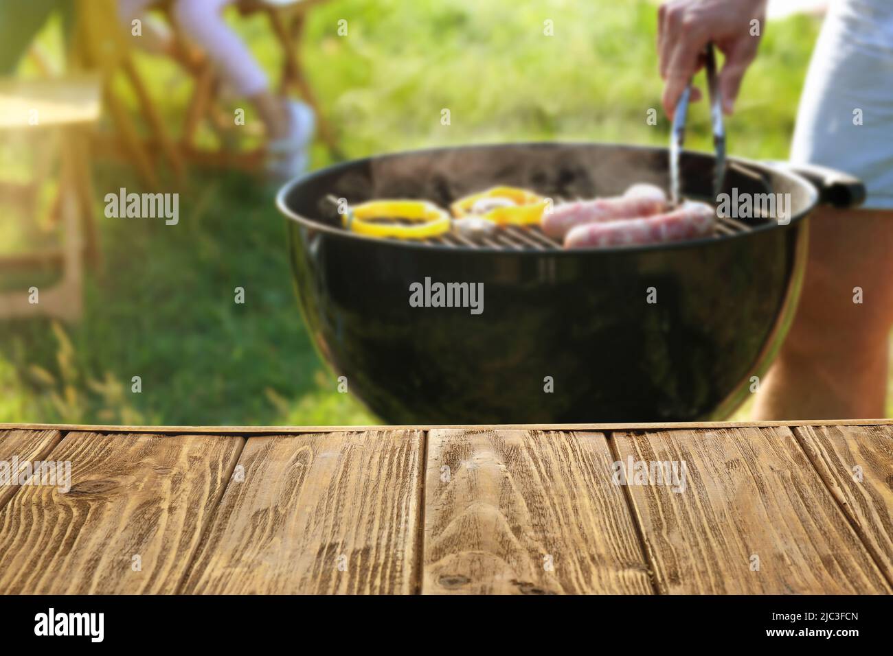 Empty wooden table at barbecue party outdoors Stock Photo - Alamy