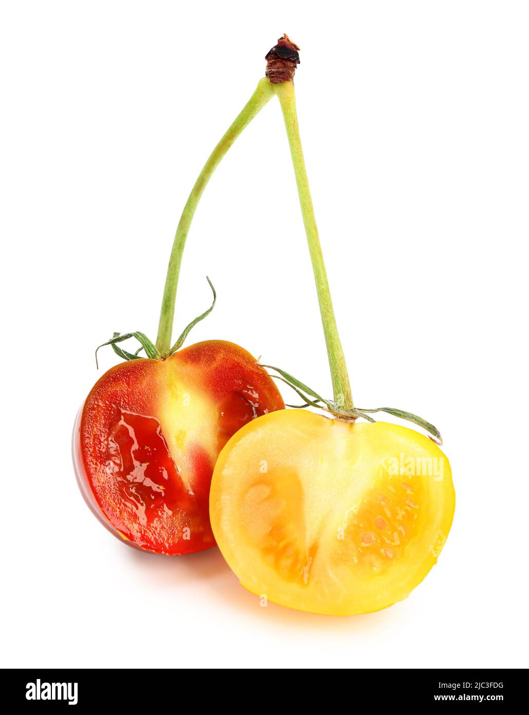 Cut cherries with tomatoes inside on white background. Concept of photo ...