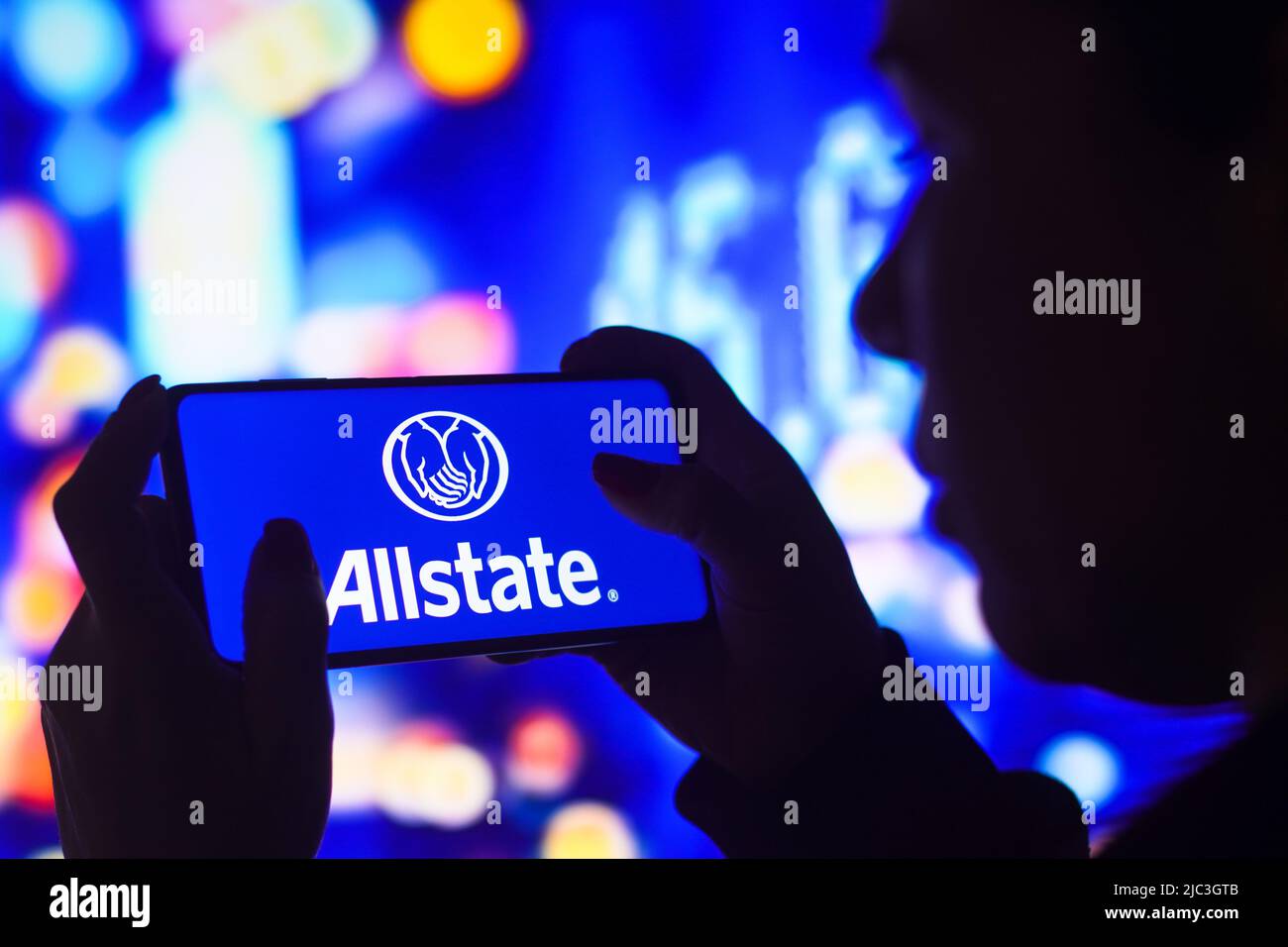 In this photo illustration, a silhouetted woman holds a smartphone with ...