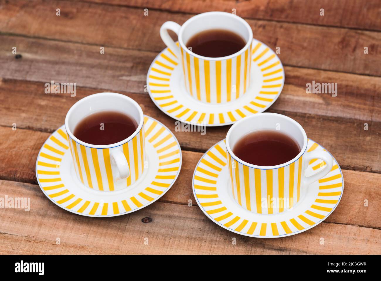 Food and drink: Black coffee in bright yellow cups and saucers Stock ...