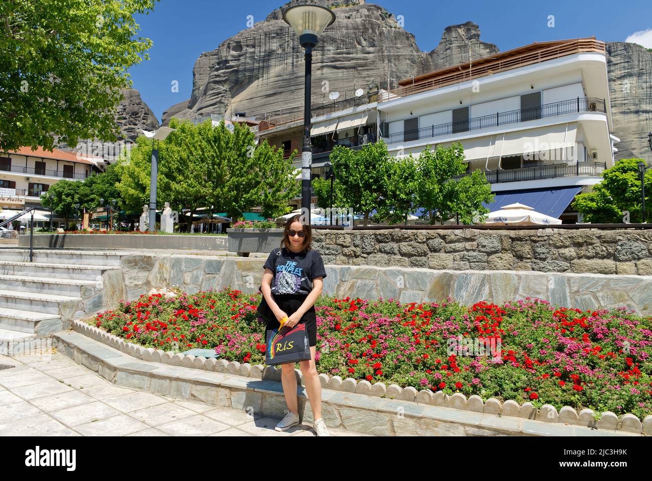 tourist is photographed in the meteor city center. Mountains in the ...