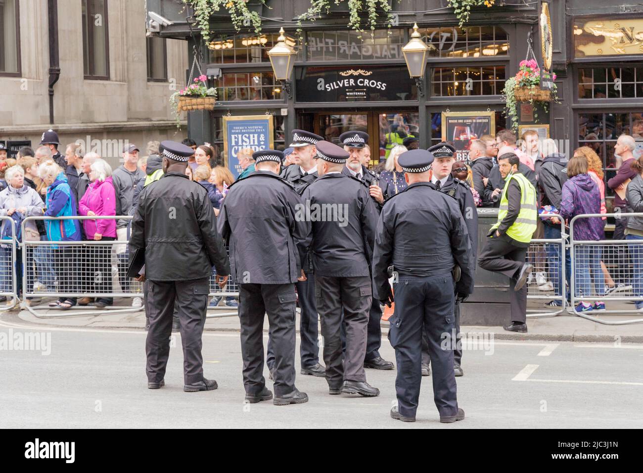 Police men keep a watchful eye on the large crowd gathered to celebrate ...