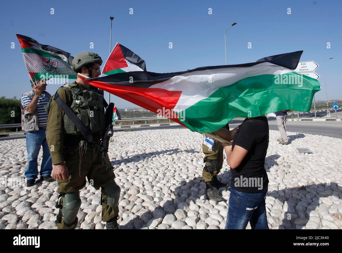 Qalqilya, Palestine. 09th June, 2022. A Palestinian holds a Palestinian ...