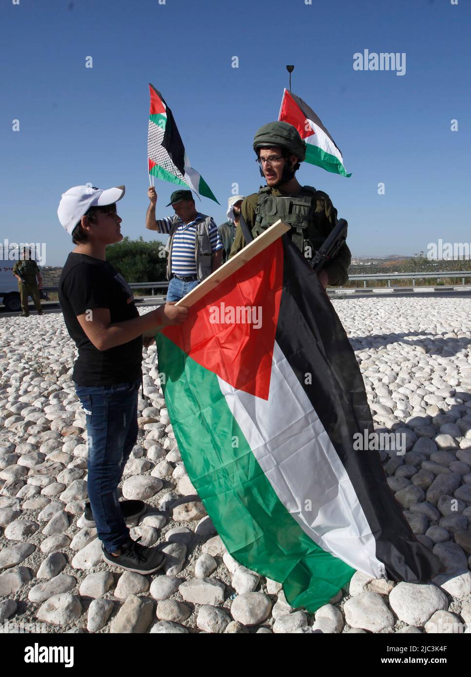 Qalqilya, Palestine. 09th June, 2022. A Palestinian holds a Palestinian ...