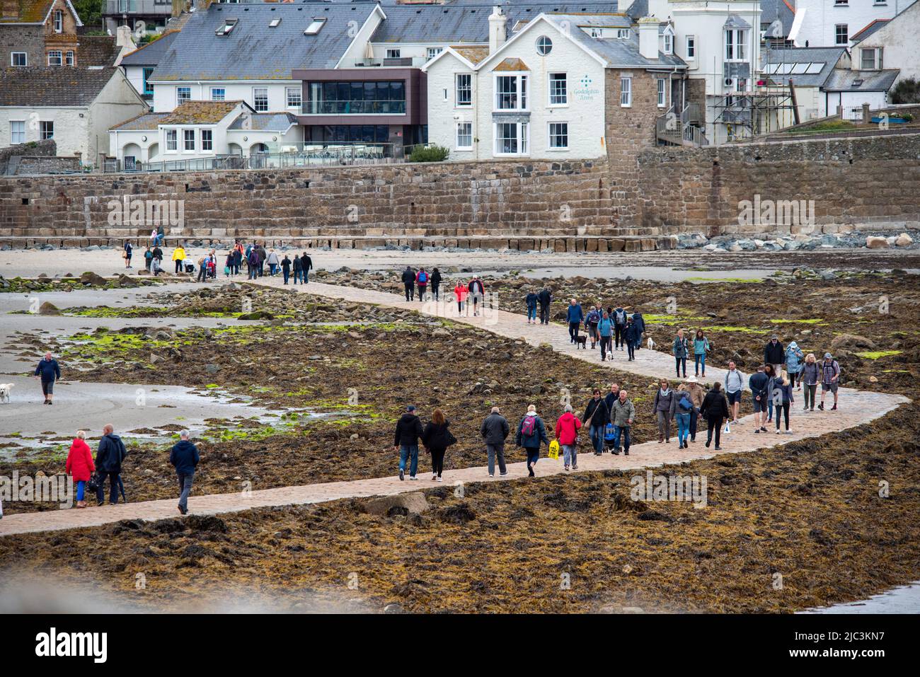 People walk along the Causeway path back from St Michael's Mount ...