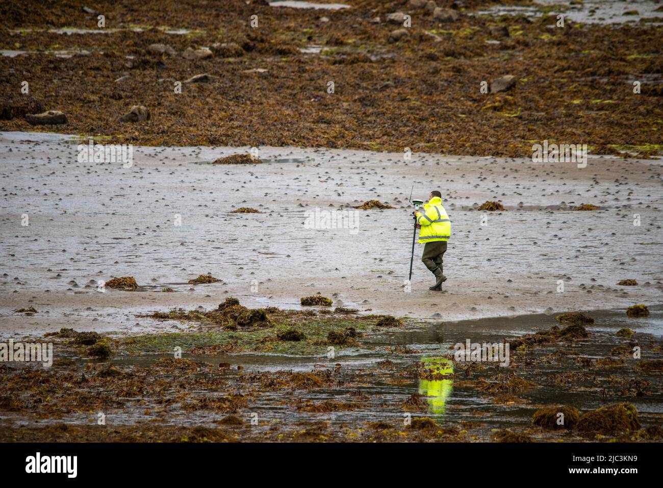 Man in high vis jacket measuring water Stock Photo - Alamy