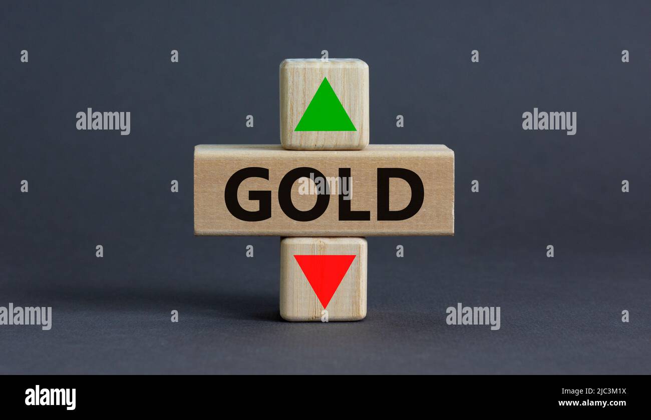 Gold price symbol. A wooden cube with arrow symbolizing that Gold price ...