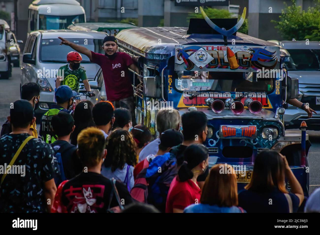 Commuters are seen waiting for the coming jeep manned by a jeepney ...