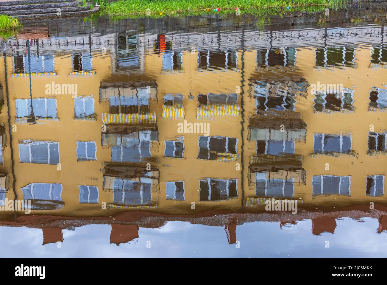 Beautiful blurred view of upside-down reflection in water of yellow ...