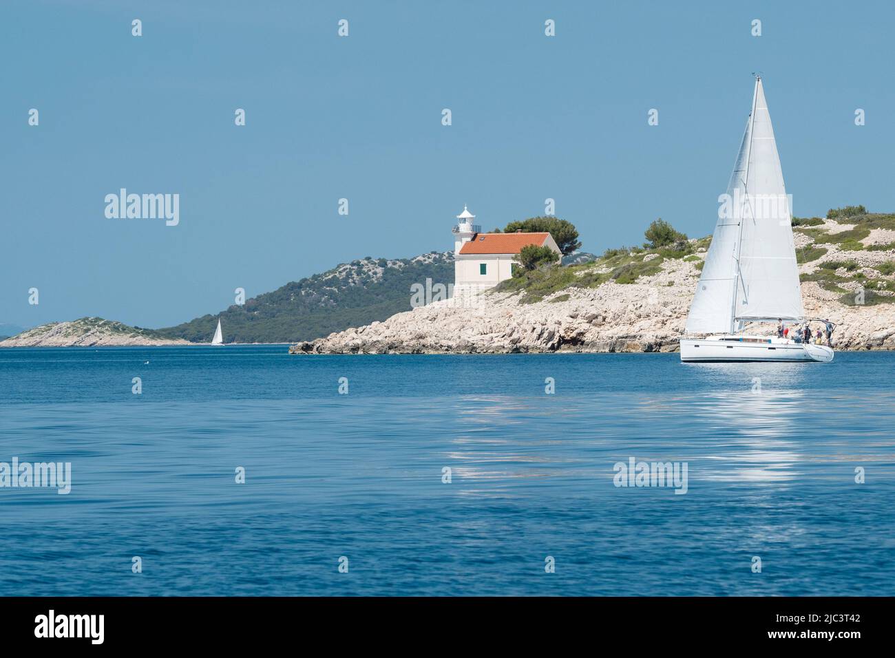 Sailing yacht next to lighthouse on island, Adriatic sea, Croatia Stock ...