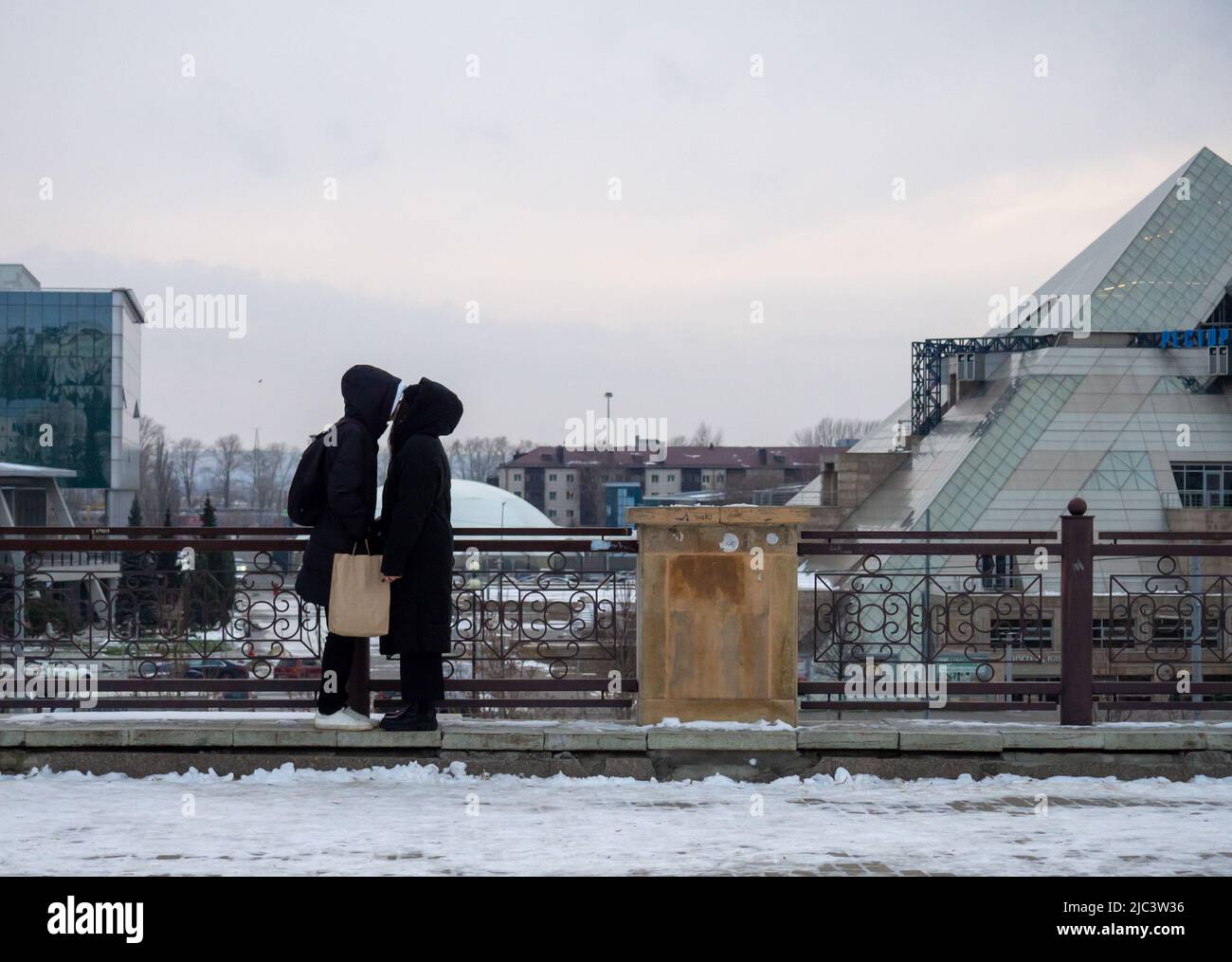 Love on the background of the city. A couple kiss on an observation ...