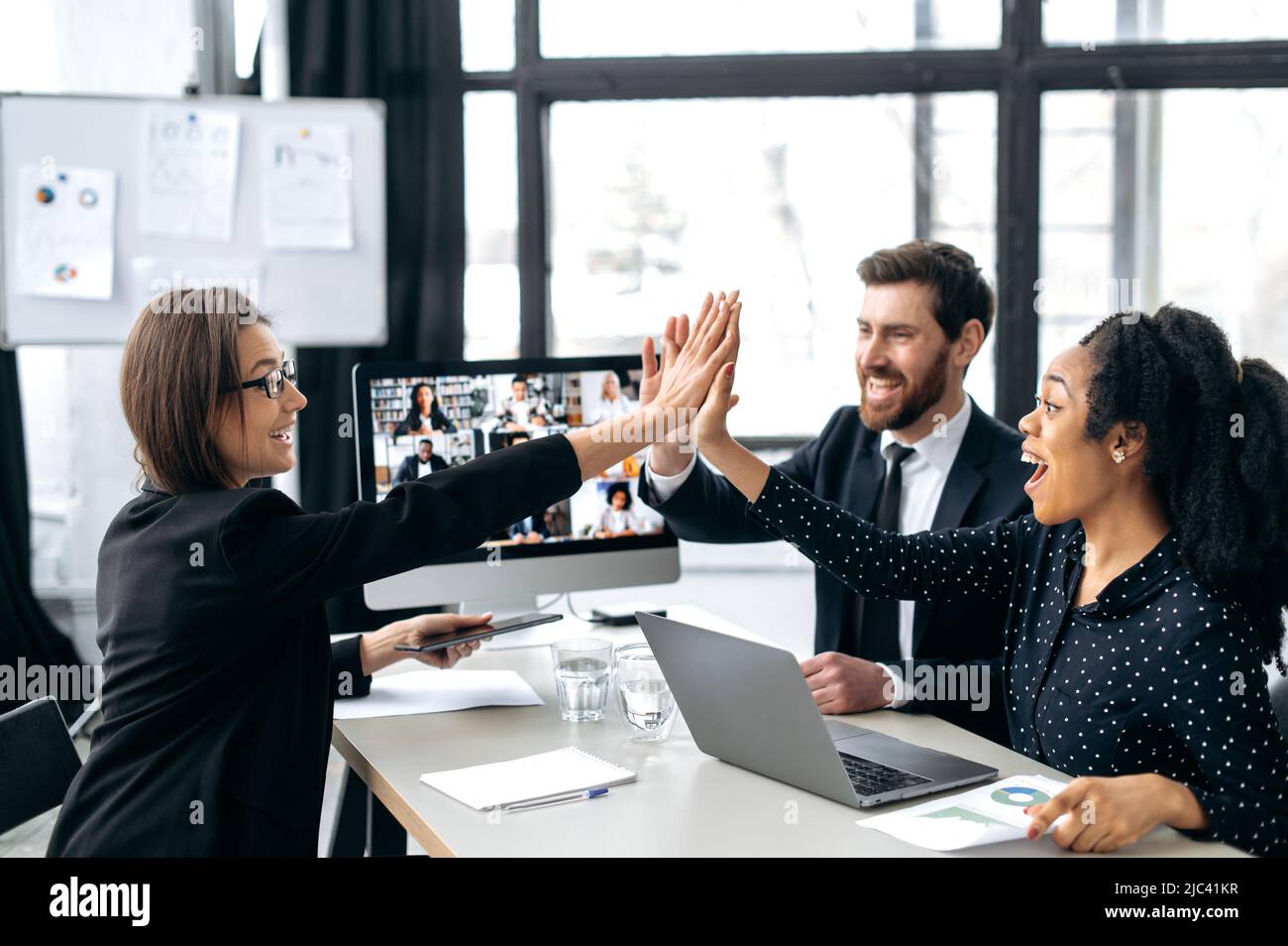 Excited business multiracial colleagues did a great job, they ...