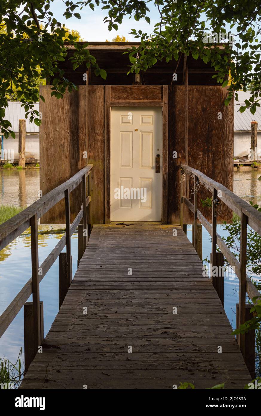 Old wooden boathouse at a lake. Wooden cabin with pier on the river.Eco ...