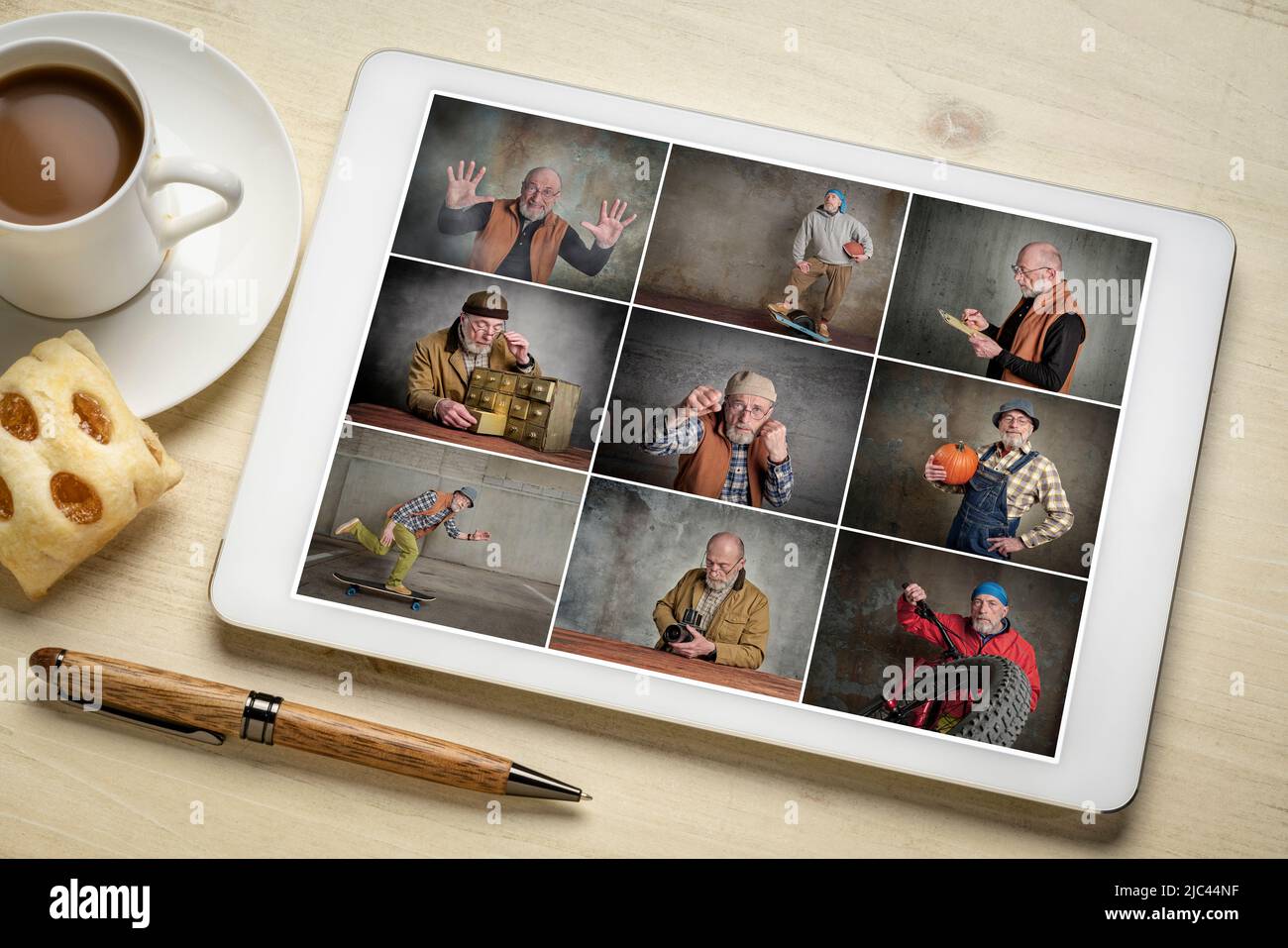 reviewing a set of studio portraits on a digital tablet featuring the ...