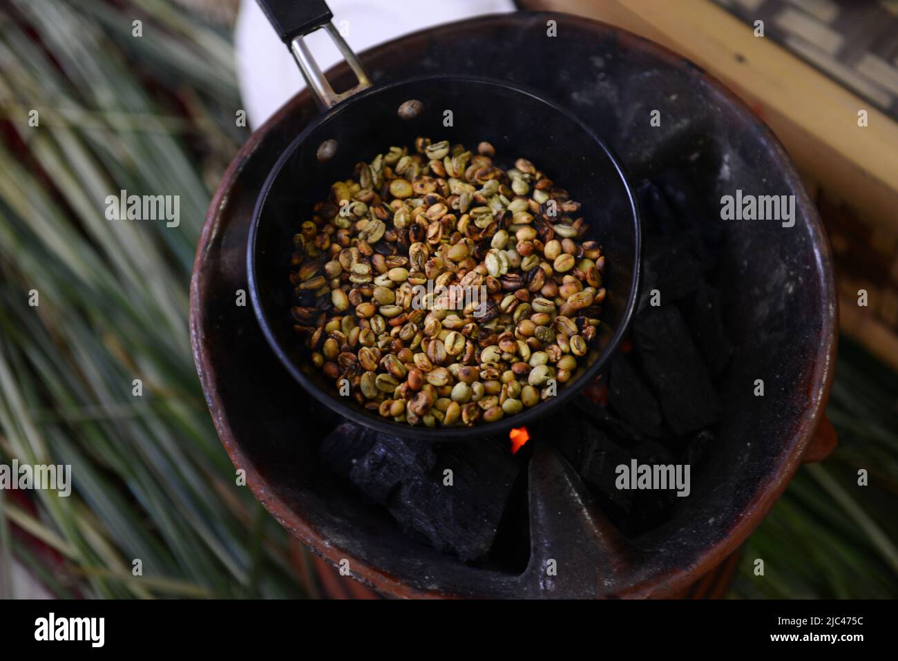 Roasting coffee beans in a traditional Ethiopian coffee ceremony Stock Photo - Alamy
