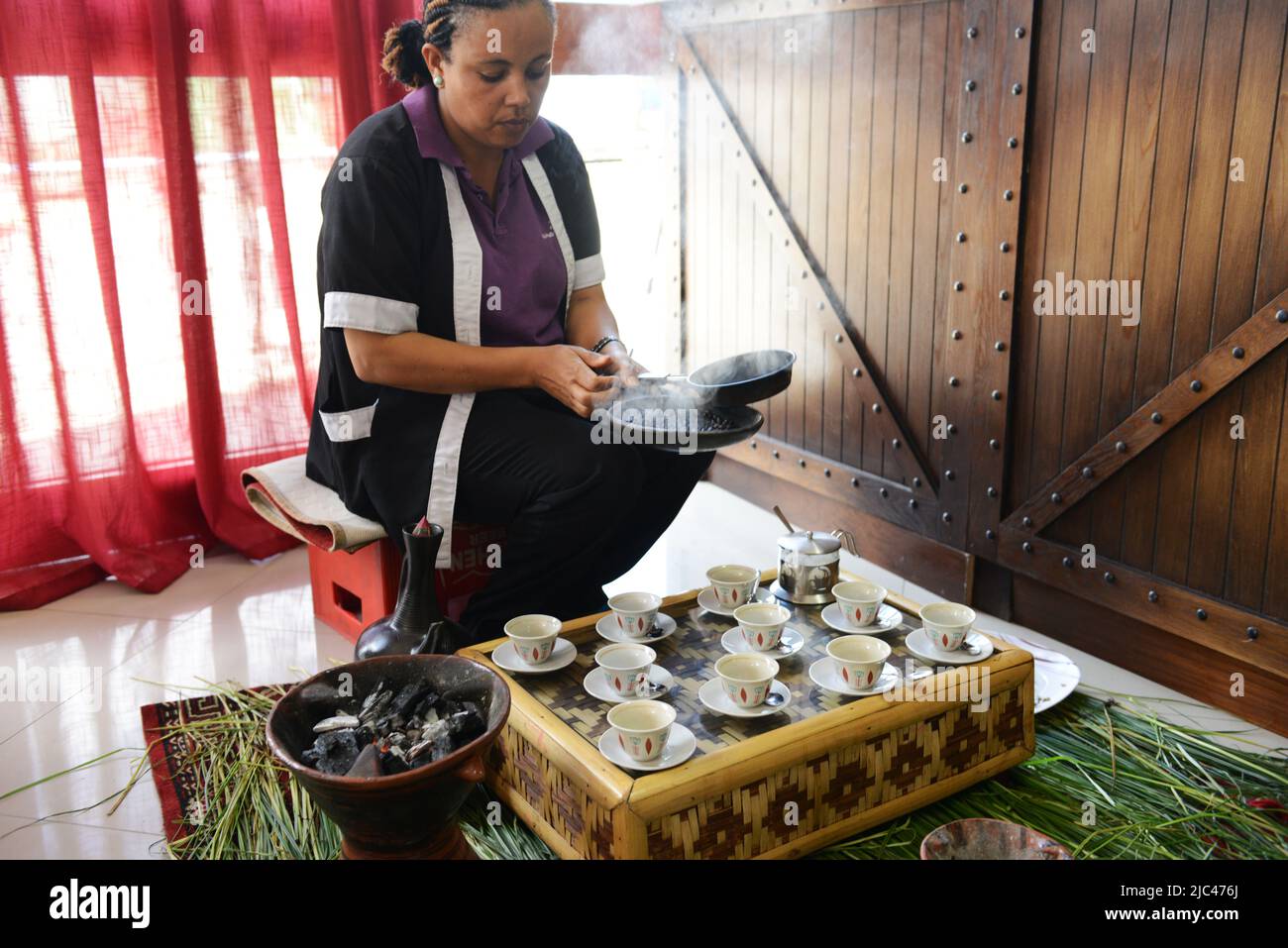 An Ethiopian woman roasting coffee beans during a traditional coffee ceremony in Addis Ababa ...