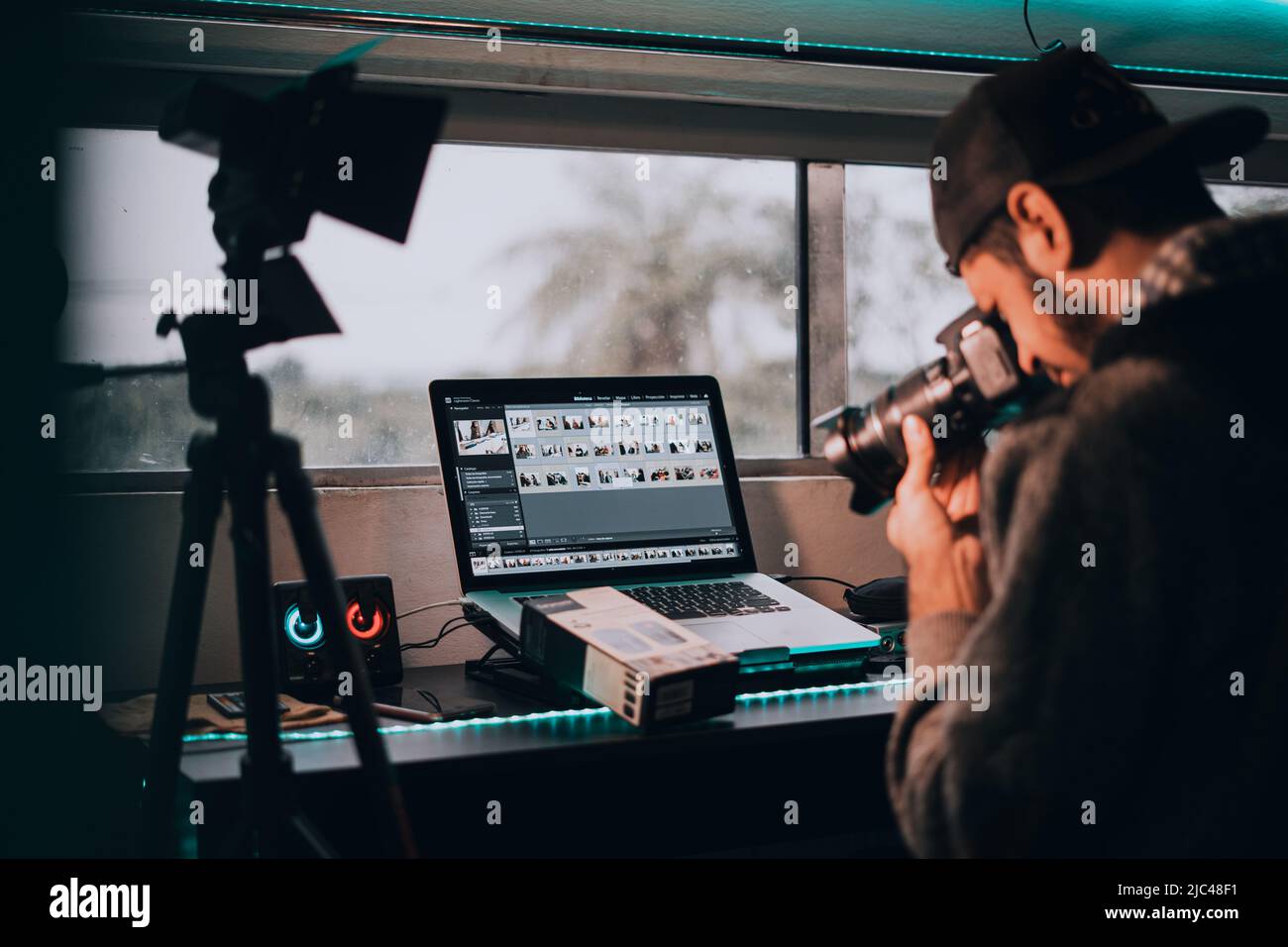 Young photographer working in his office Stock Photo - Alamy