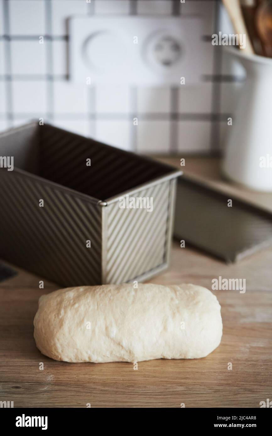 The process of making homemade toast bread in a mold. The concept of ...