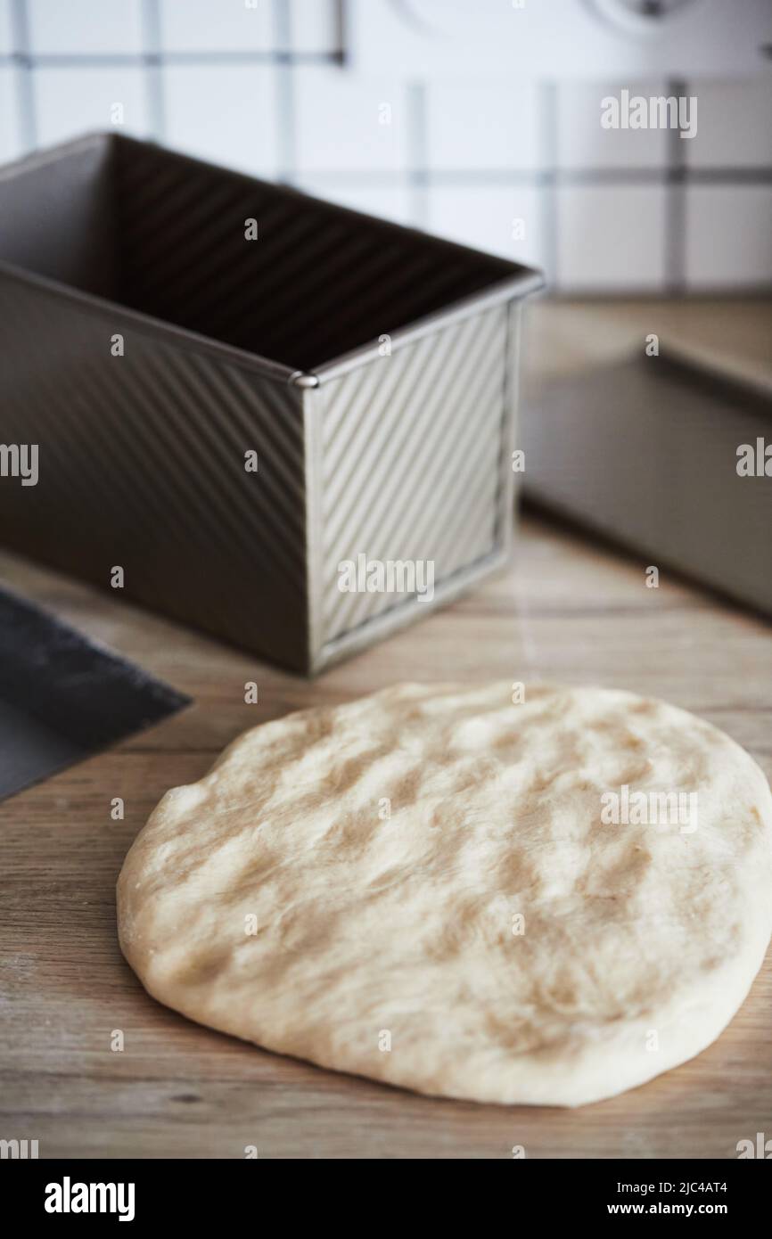 The process of making homemade toast bread in a mold. The concept of ...