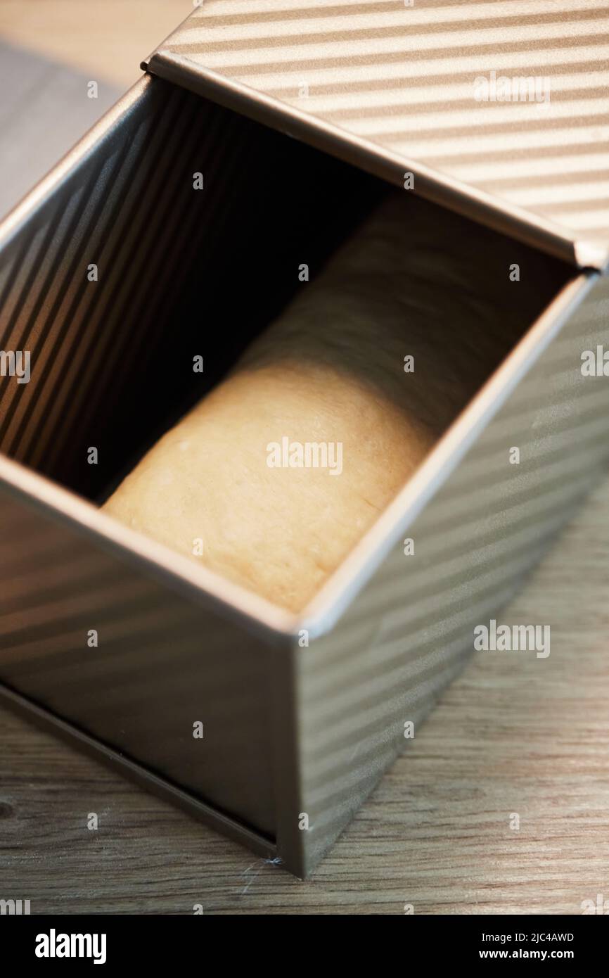 The process of making homemade toast bread in a mold. The concept of ...