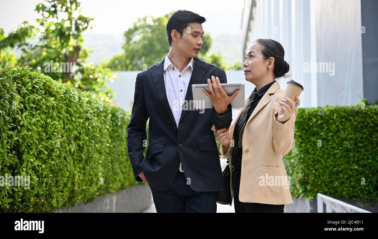 Successful asian male banker or businessman talking having a ...