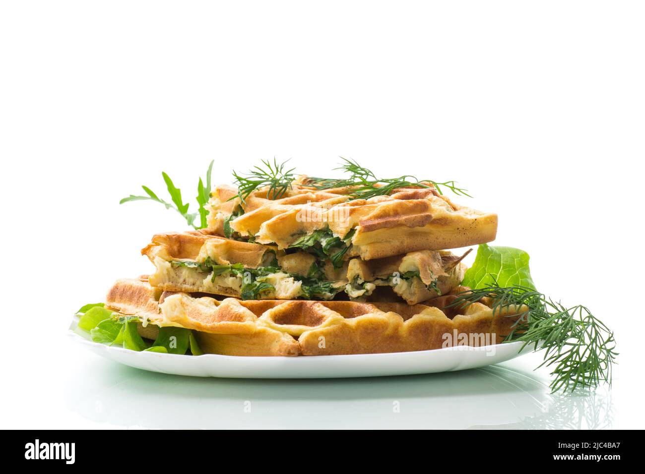 Homemade fried vegetable waffles with greens inside isolated on white ...