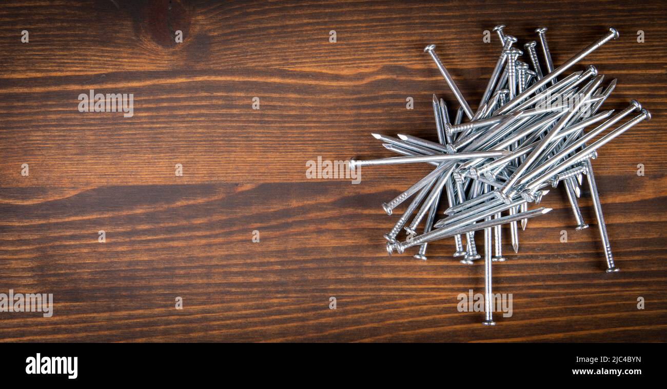 Construction nail stack on a wooden background, copy space Stock Photo ...
