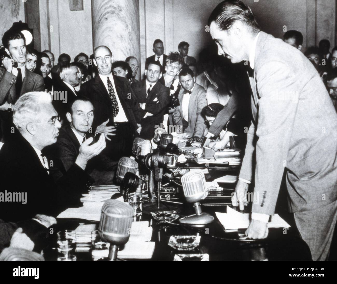 Howard Hughes (right) confers with Senator Homer Ferguson, chairman of ...