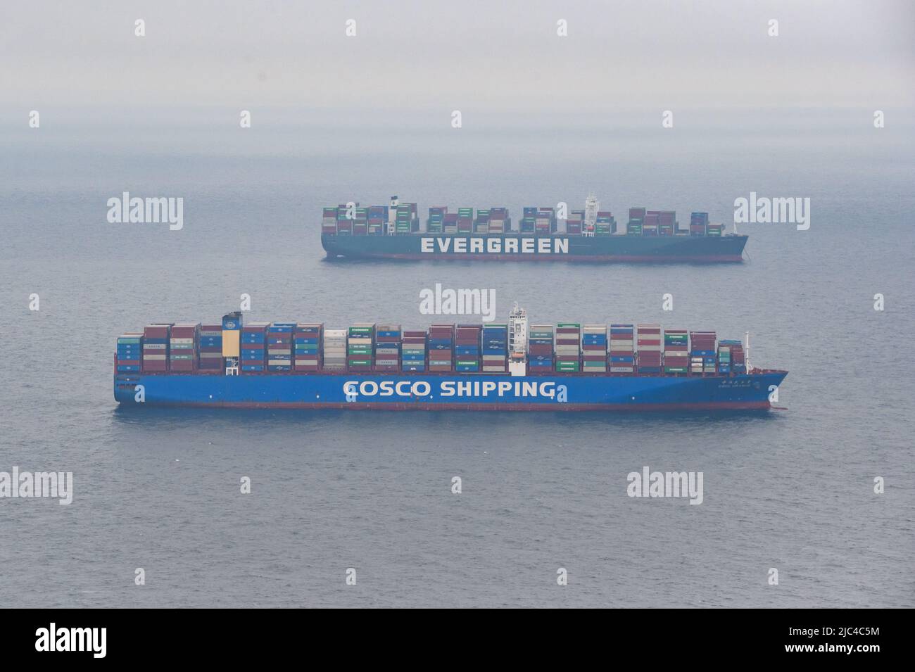Hamburg, Germany. 09th June, 2022. The container ship CSCL Uranus (front) of Cosco Shipping ...