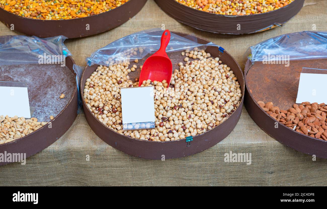 Peeled hazelnuts on a market stall in yellow tones close-up Stock Photo ...