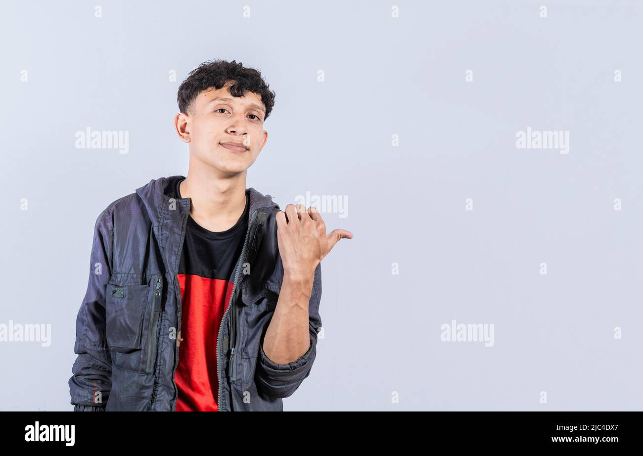 Cheerful guy with a friendly smile shows you the direction to a nice ...