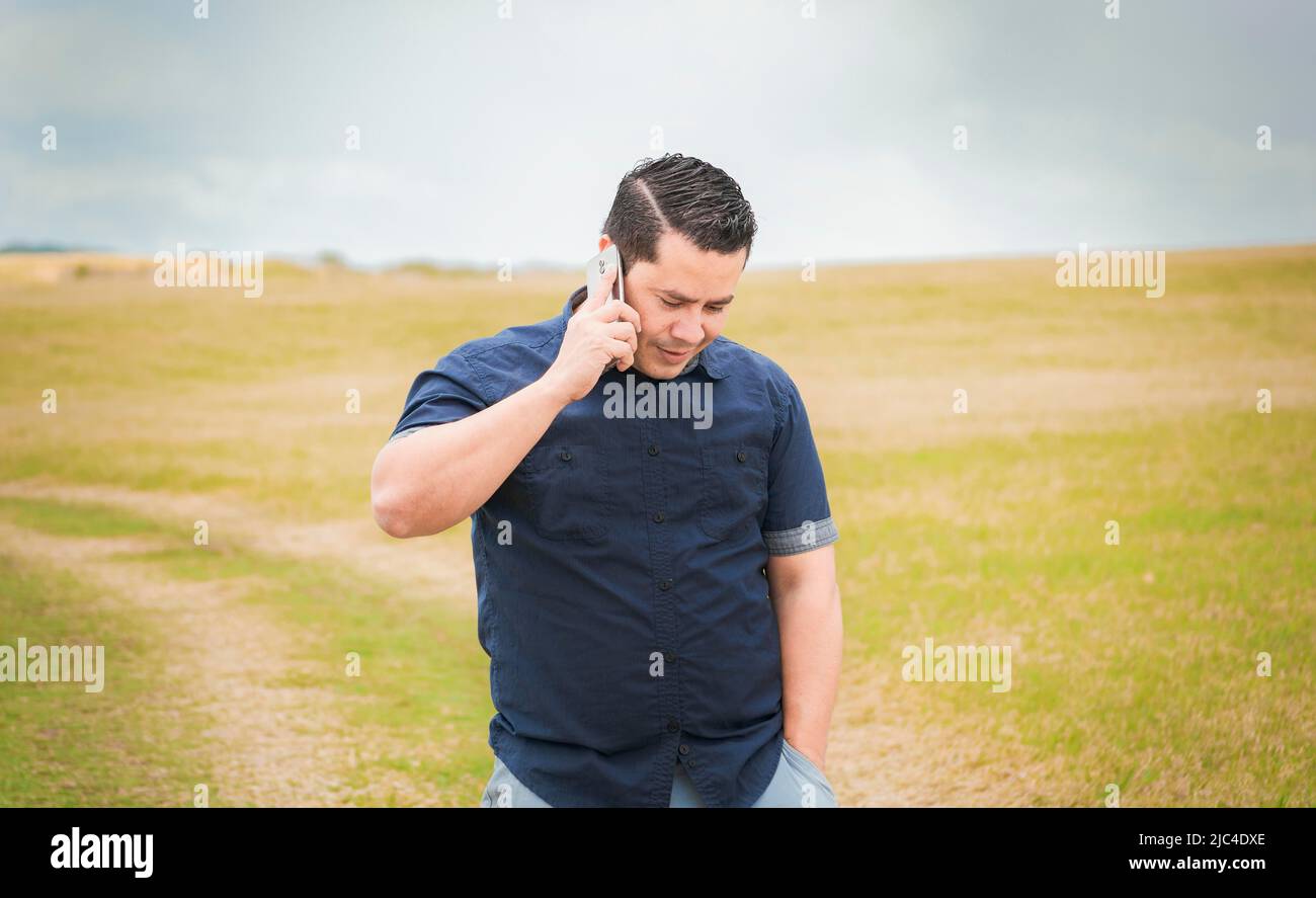 Man calling on the phone in the field, man on a road talking on the ...
