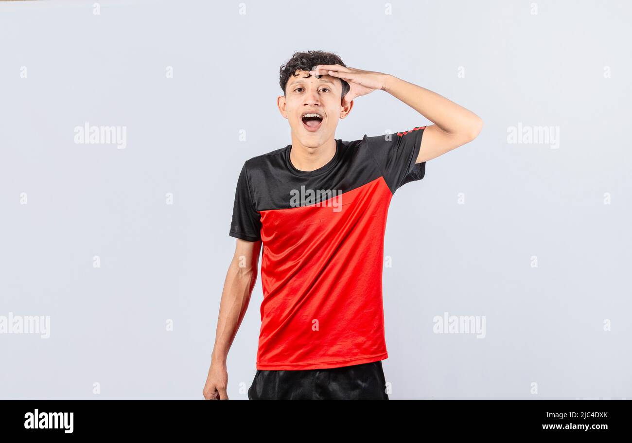 Amazed young man with his mouth open with his hand on his forehead ...