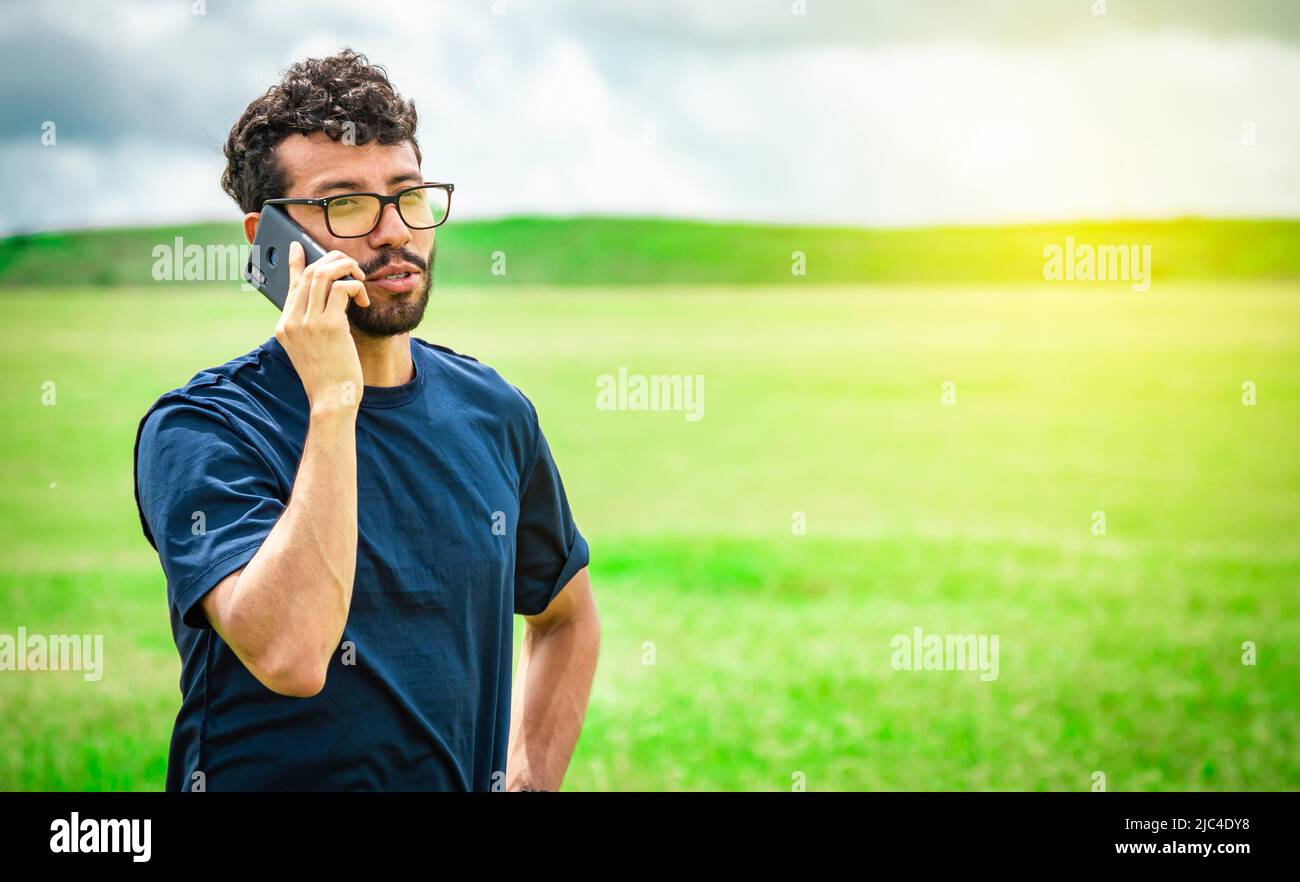 Man calling on the phone in the field, man on a road talking on the ...