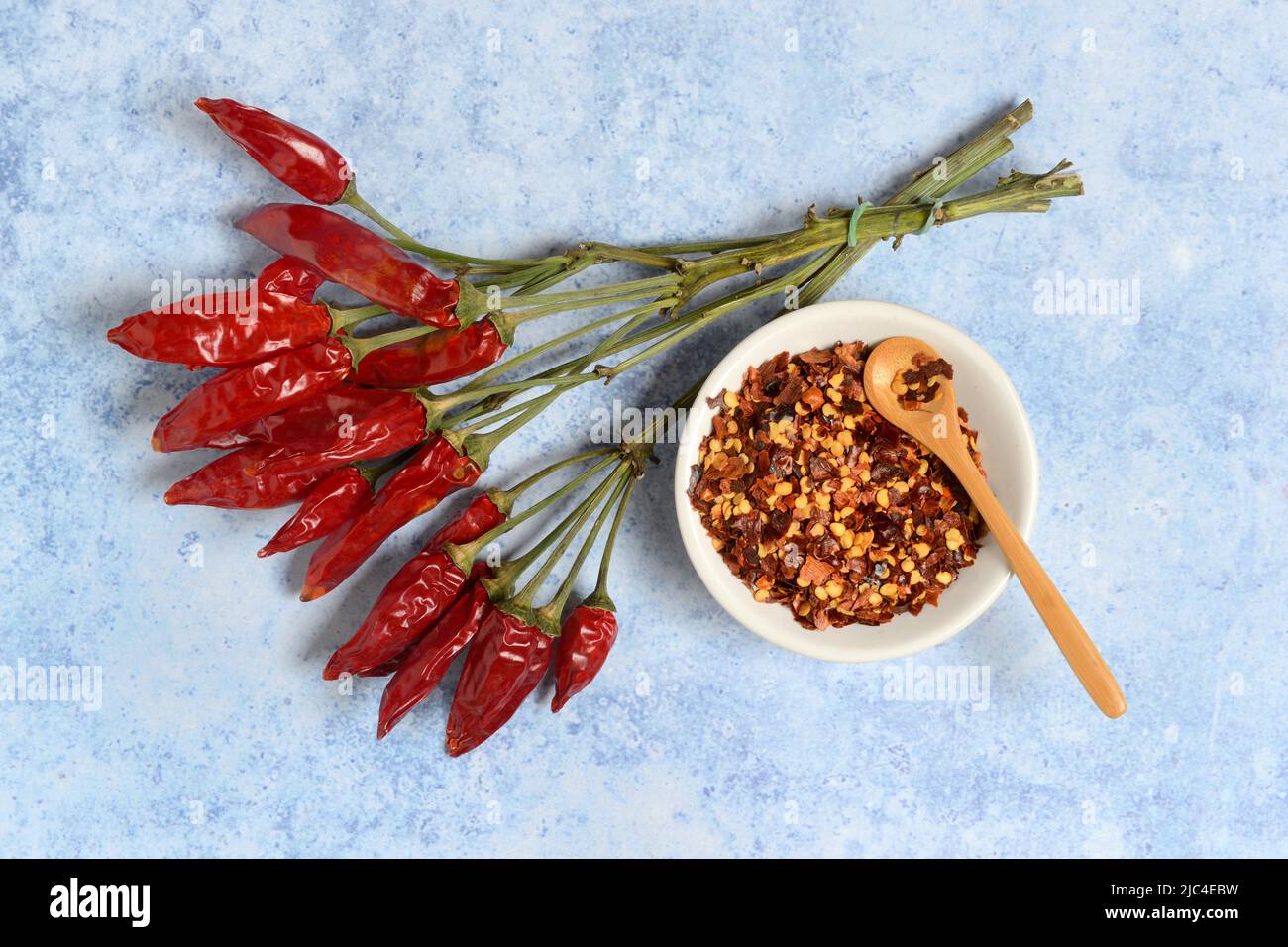 Dried chilli peppers (Capsicum annuum) in bunch and chilli flakes in ...