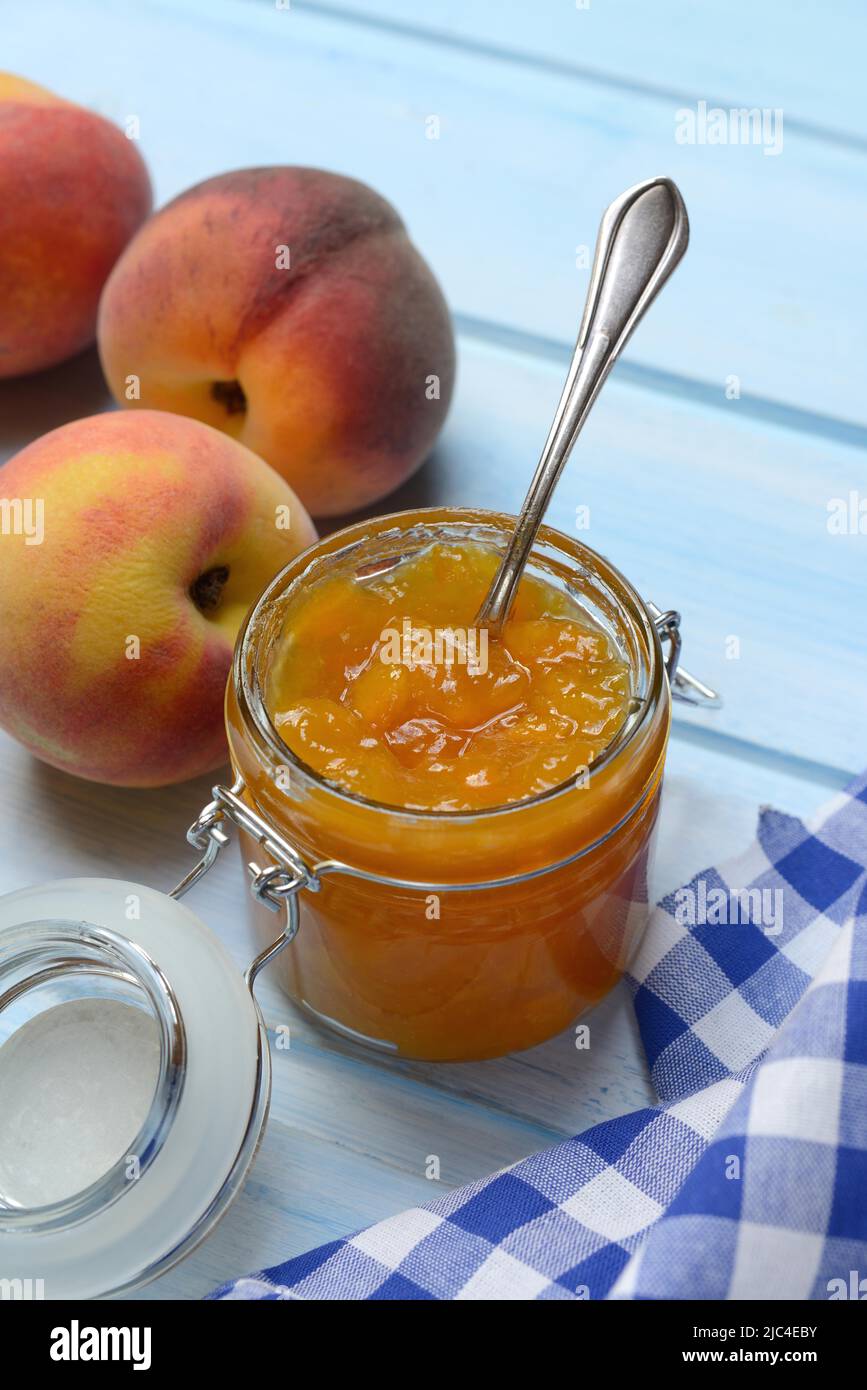 Peach jam in glass and peaches Stock Photo - Alamy