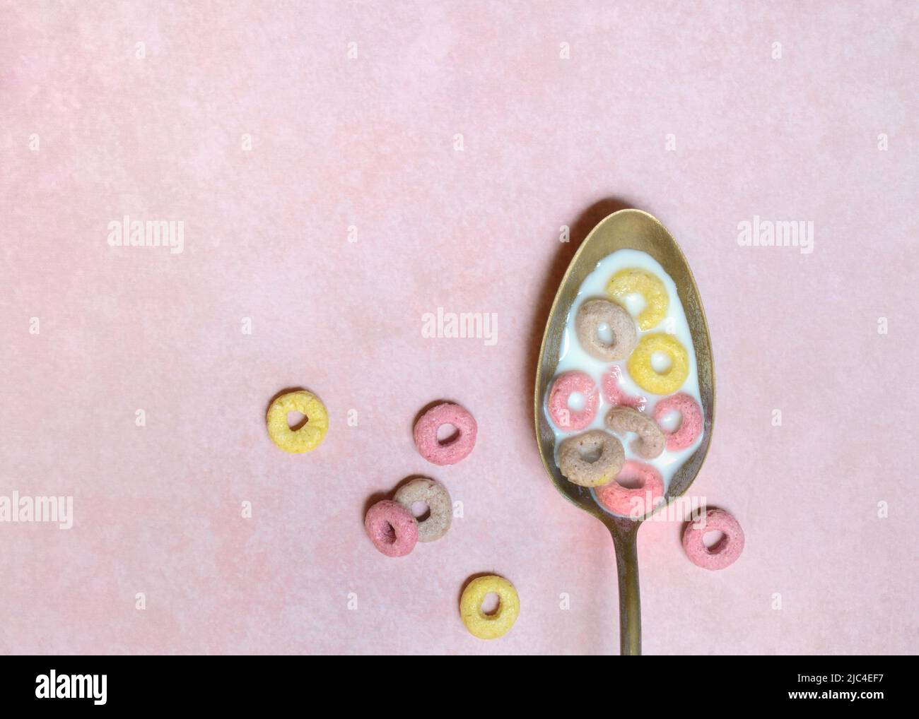 Fruit-flavoured cereal rings in spoon, children's breakfast, cereals ...