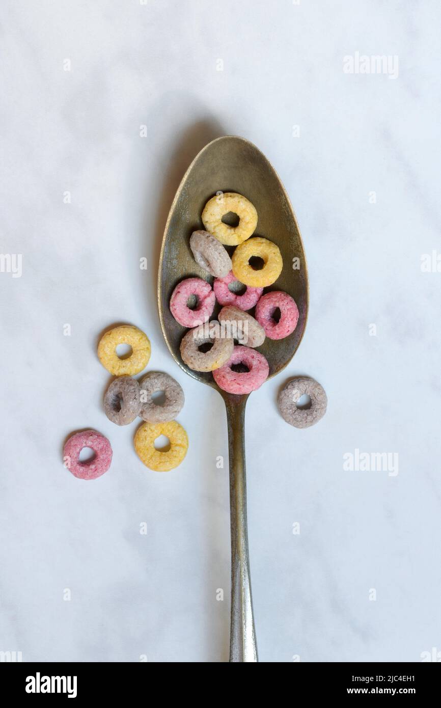 Fruit-flavoured cereal rings in spoon, children's breakfast, cereals ...