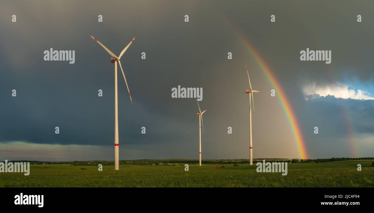 colourful rainbow over a wind farm Stock Photo - Alamy